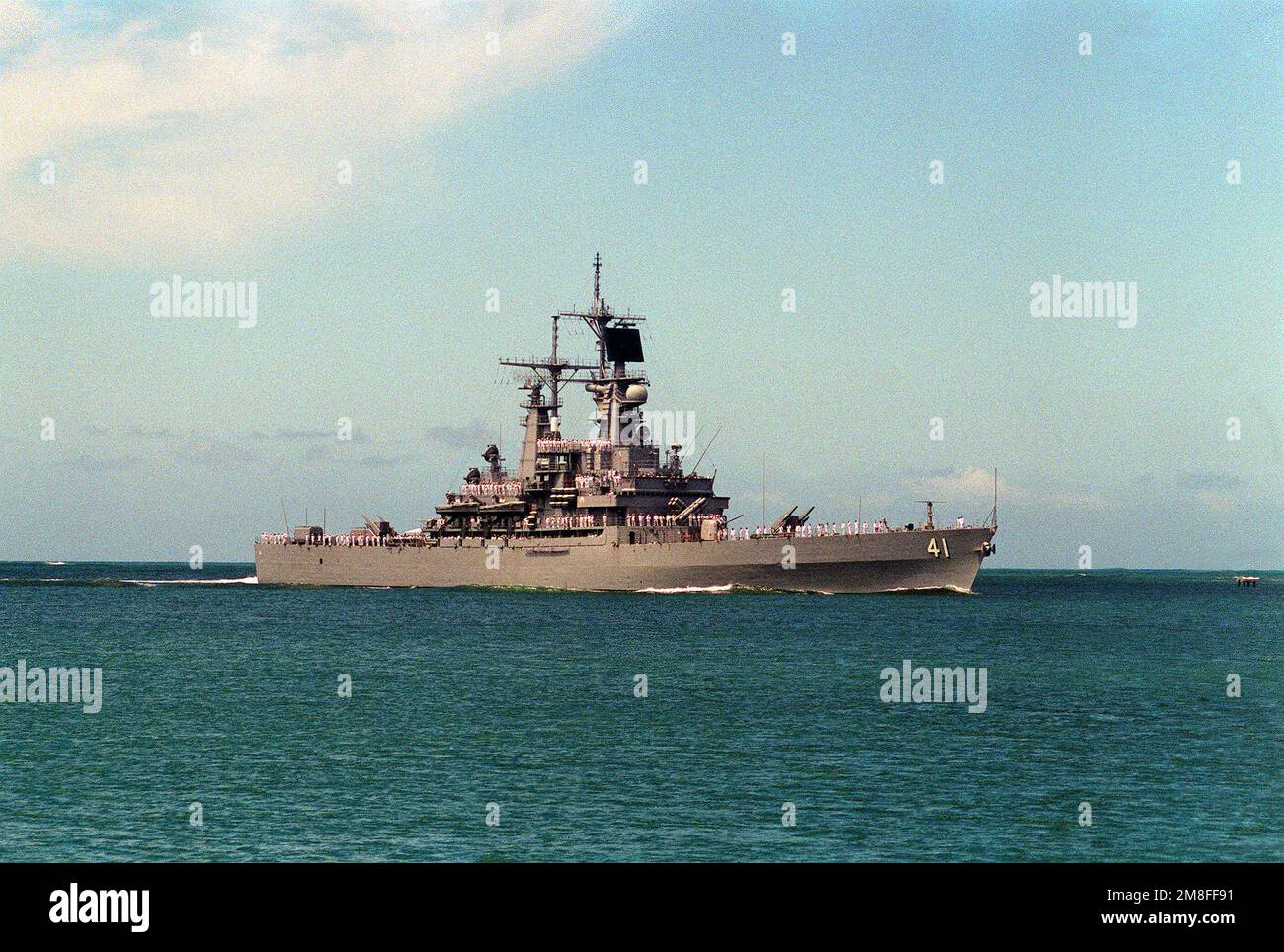 Crew members man the rails aboard the nuclear-powered guided missile ...