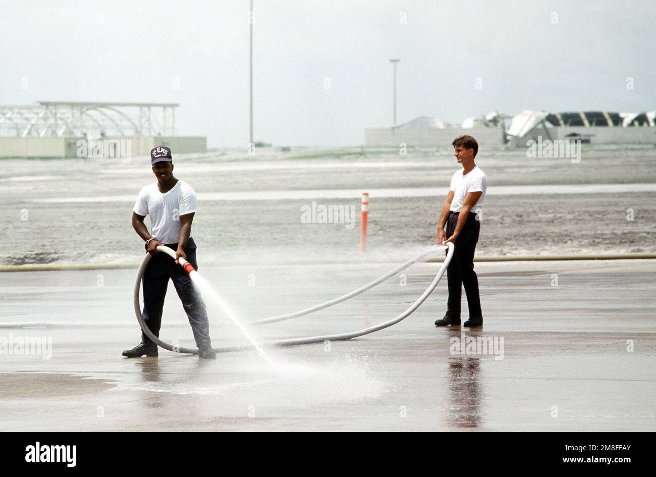 Airmen from the 3rd Equipment Maintenance Squadron rinse volcanic ash ...