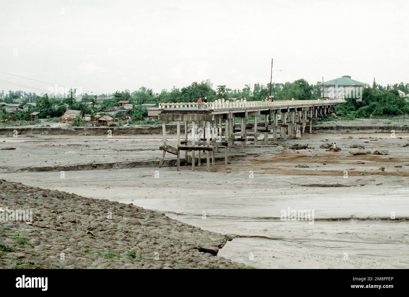 Filipinos walk along Friendship Bridge to Clark Air Base. The bridge ...