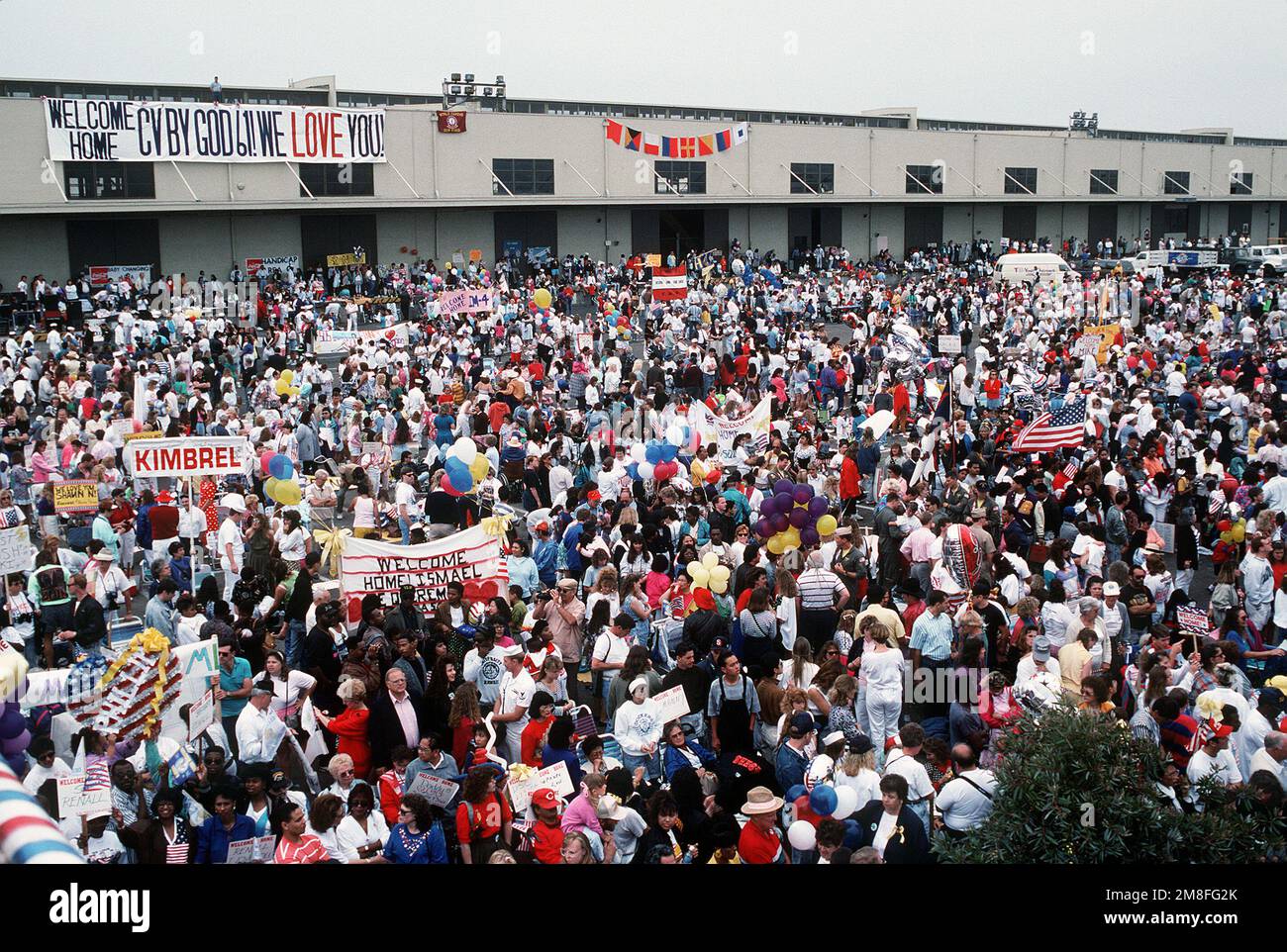 A large crowd of family and friends gathers to welcome crew members ...