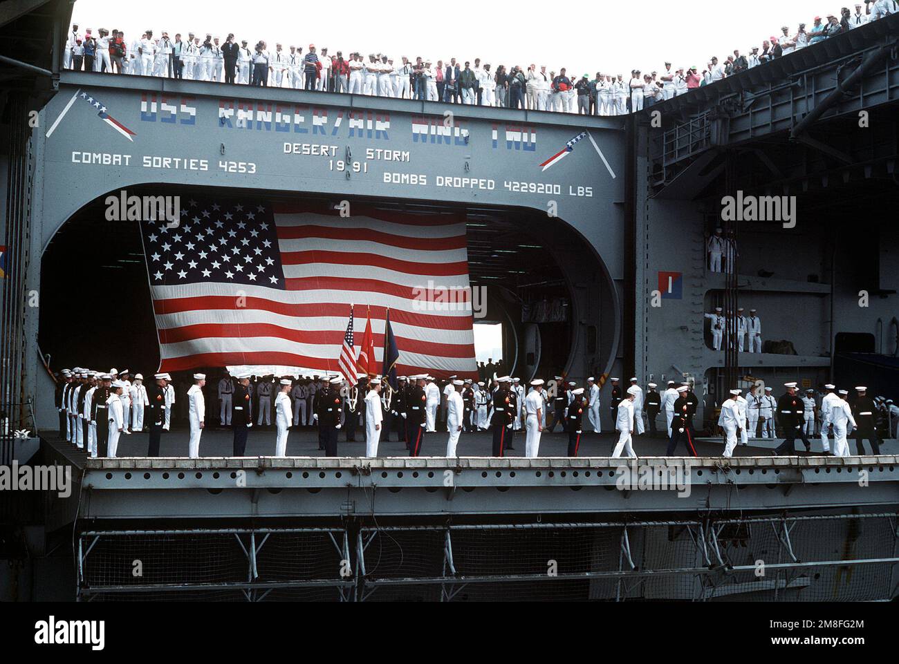 Sailors and Marines aboard the aircraft carrier USS RANGER (CV-61) take ...