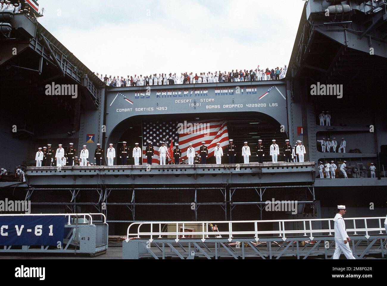 Sailors and Marines aboard the aircraft carrier USS RANGER (CV-61) take ...