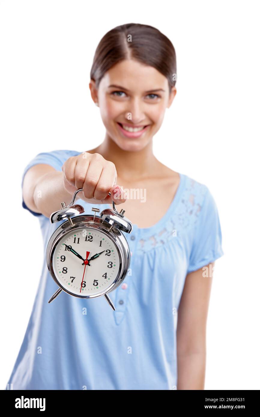 Portrait, clock and time with a model woman in studio isolated on a ...