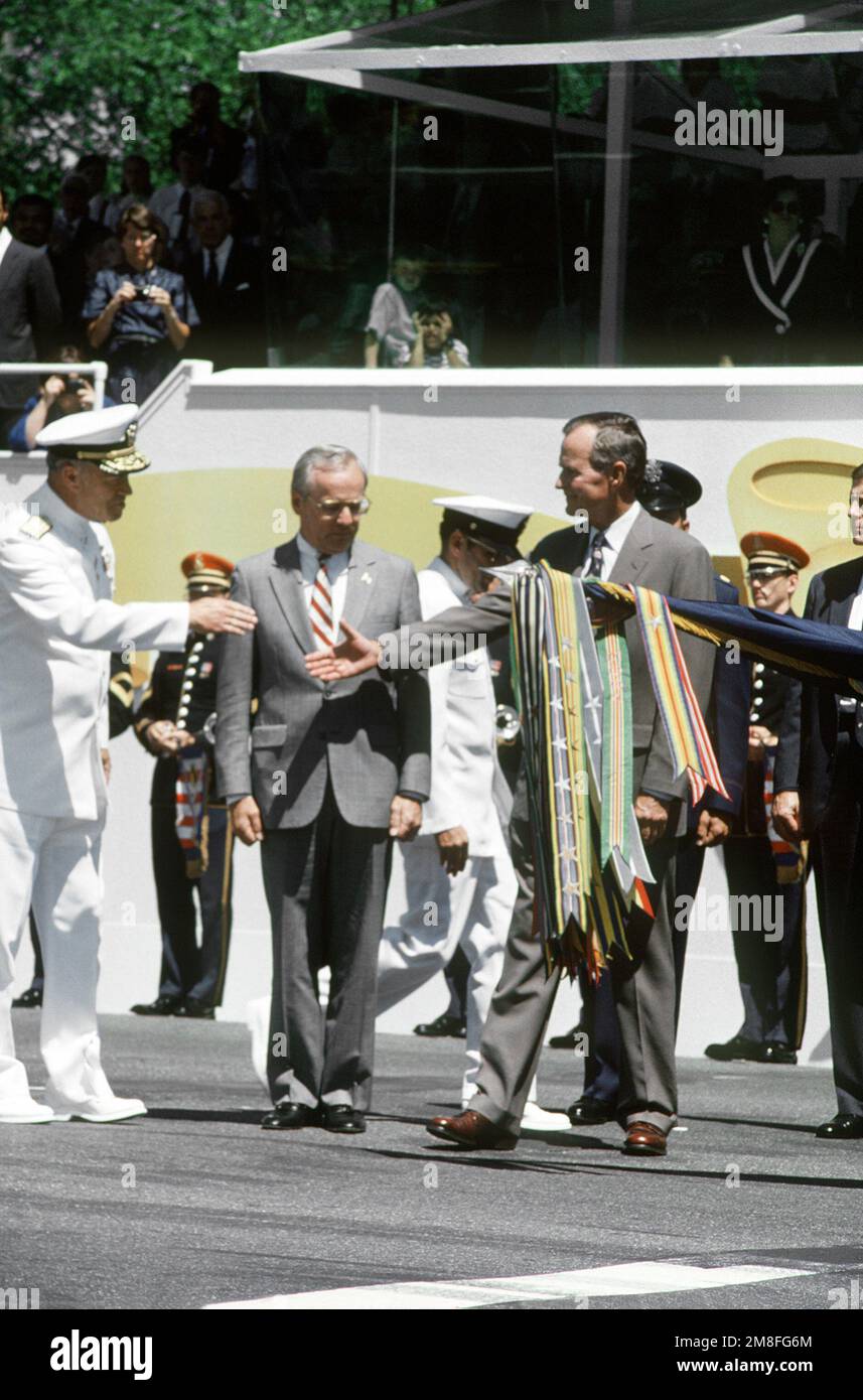President George H.W. Bush prepares to shake hands with Adm. Frank B ...