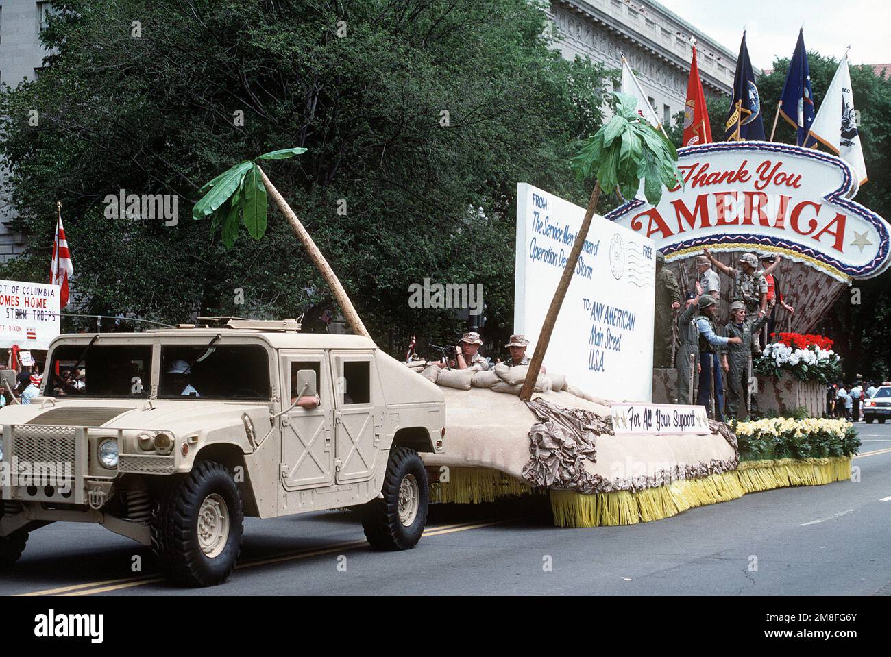A float pulled by an M998 High-Mobility Multipurpose Wheeled Vehicle ...