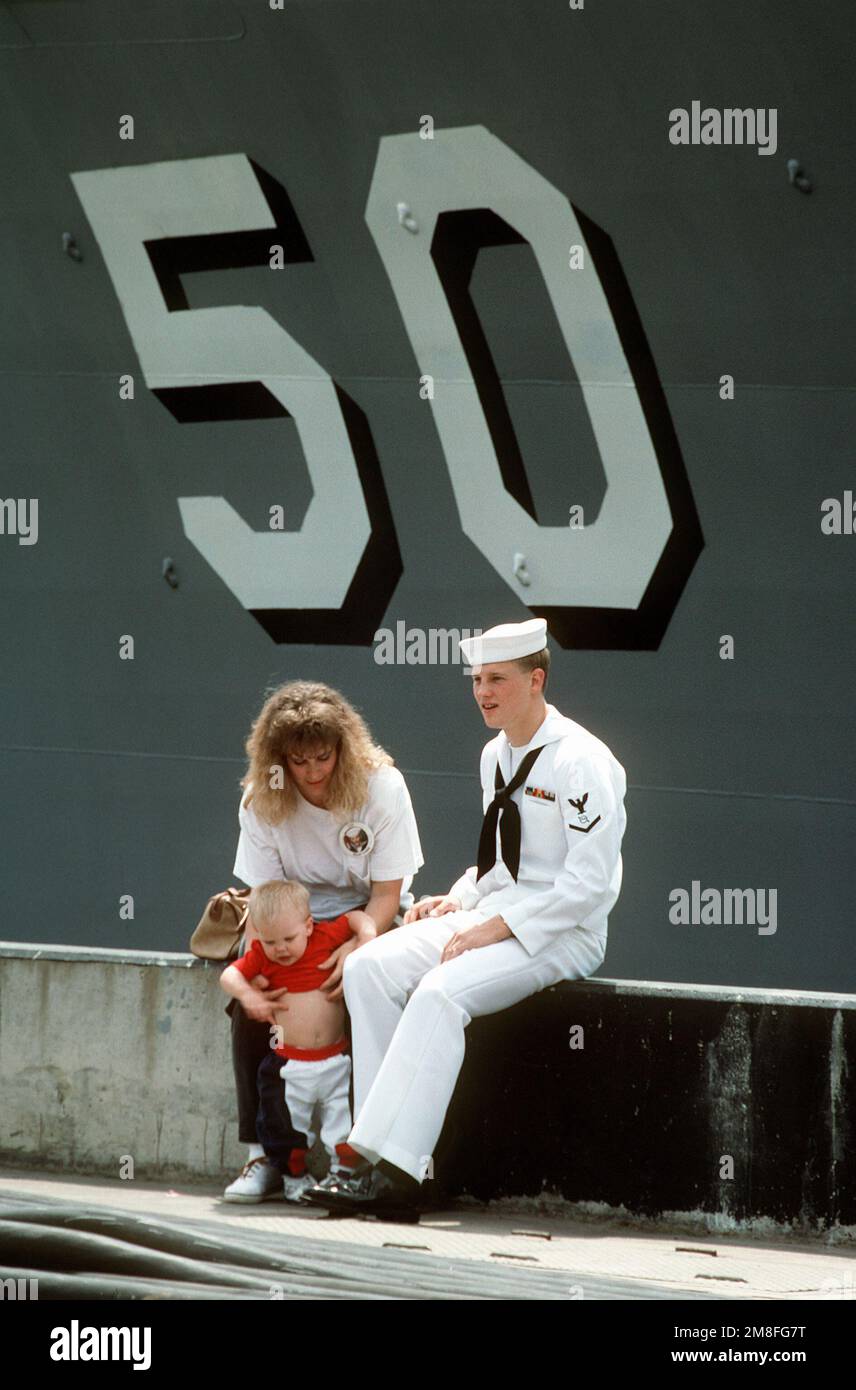 A sailor from the guided missile cruiser USS VALLEY FORGE (CG-50) sits ...