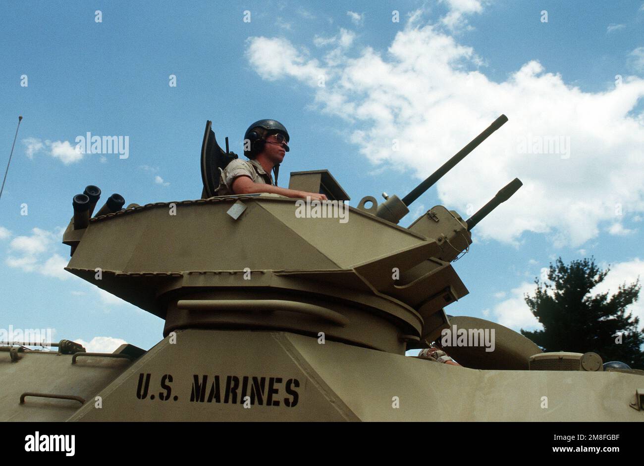 A Marine mans the gunner's turret aboard an AAVP-7A1 amphibious assault ...