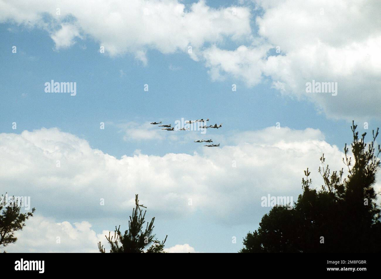 A flight of U.S. Navy aircraft passes over the parade route during the ...