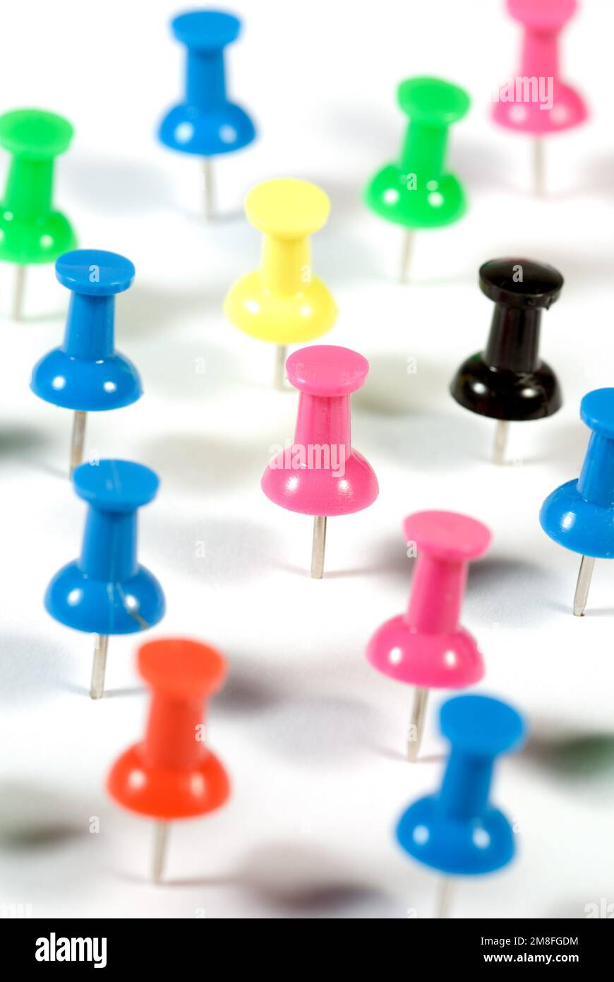 Push pins on white paper background Stock Photo - Alamy