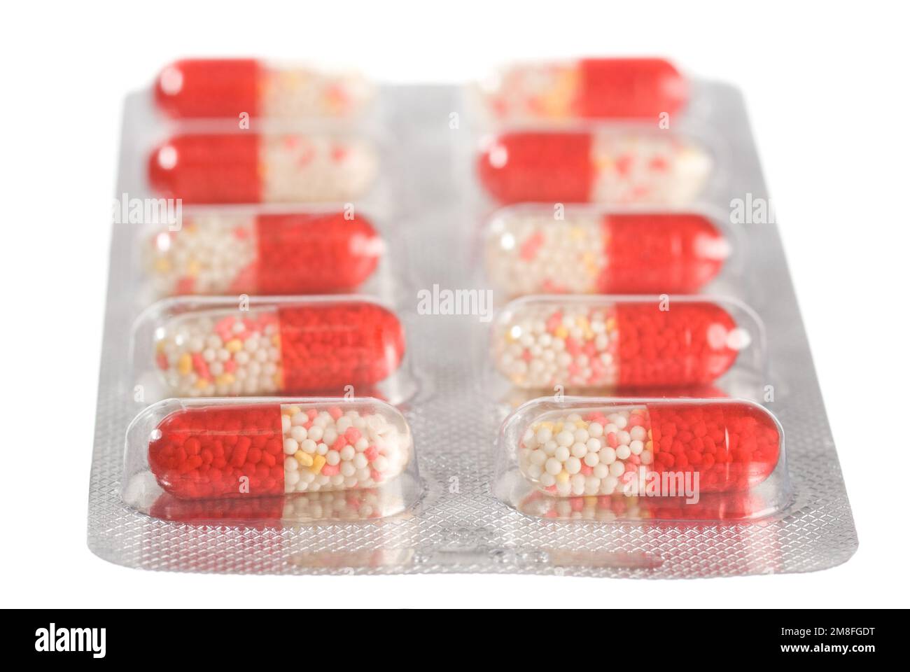 A pack of red capsules on white Stock Photo - Alamy