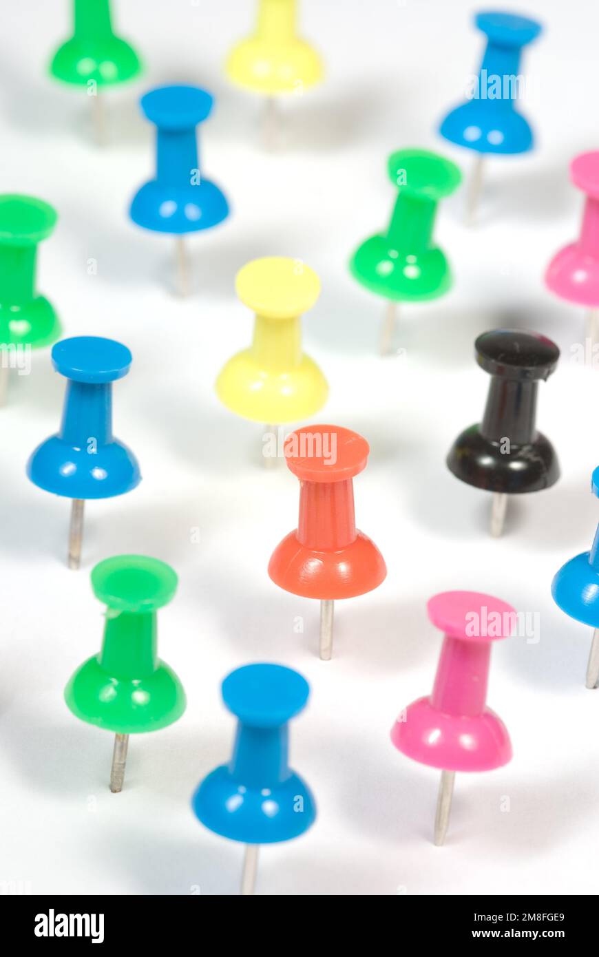 Push pins on white paper background Stock Photo - Alamy