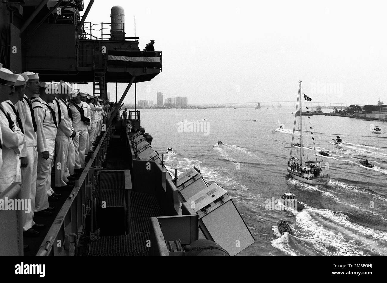 Crew members manning the rails aboard the aircraft carrier USS RANGER ...