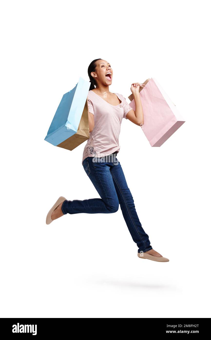 Success, fashion and woman jump with shopping bags in studio isolated ...