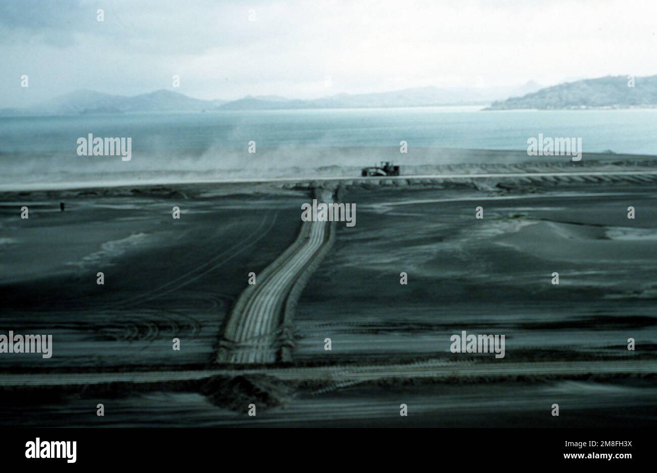 A road grader clears ash from the runway at Cubi Point Naval Air ...