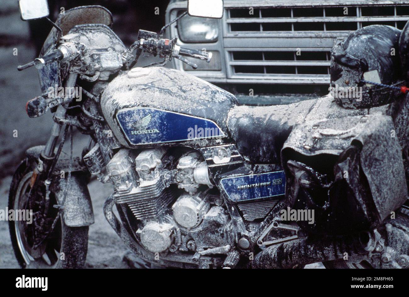 Ash covers a motorcycle in the parking lot at Papaga Agricultural ...