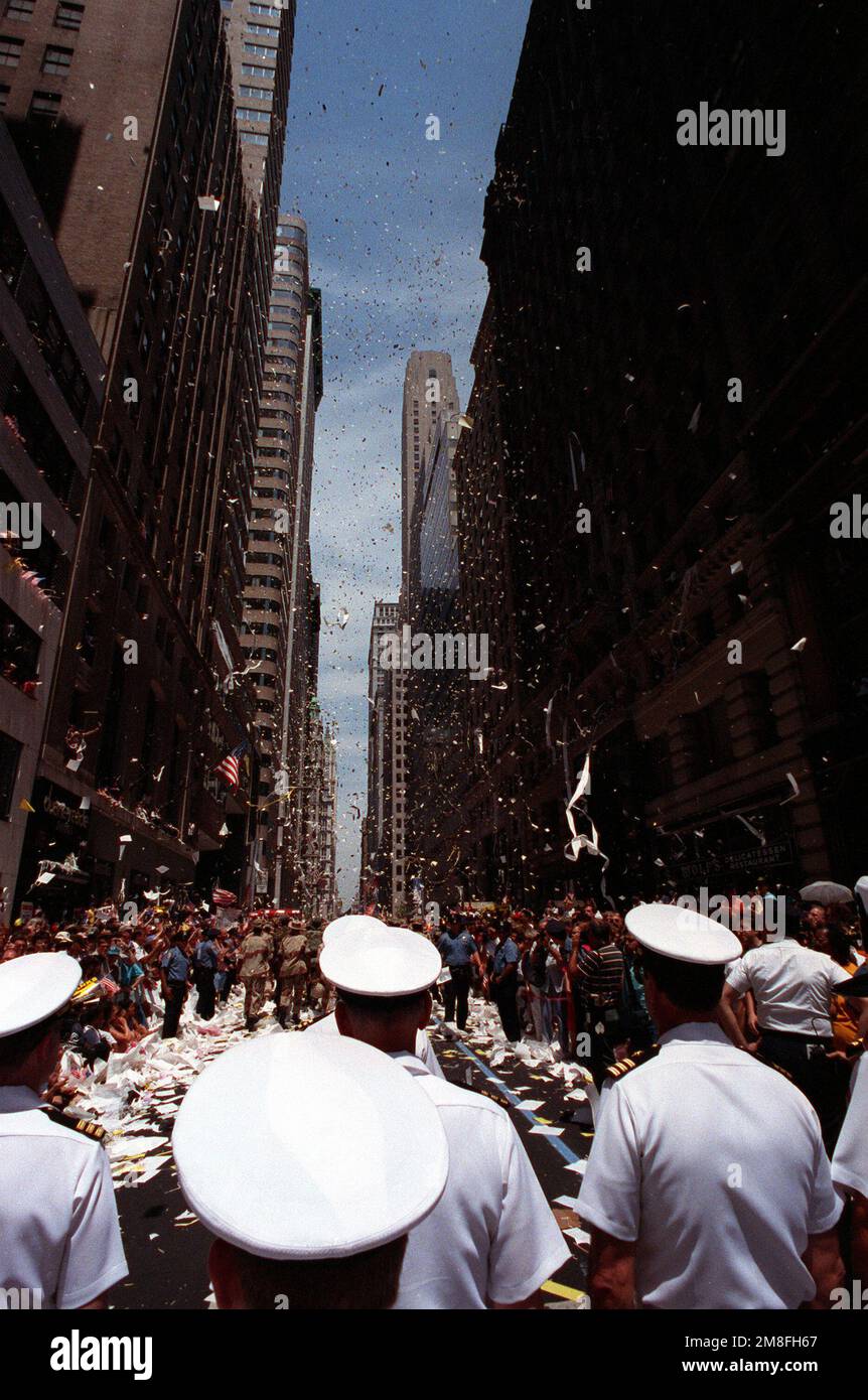 Confetti rains down from the windows above as a group of U.S. Navy ...