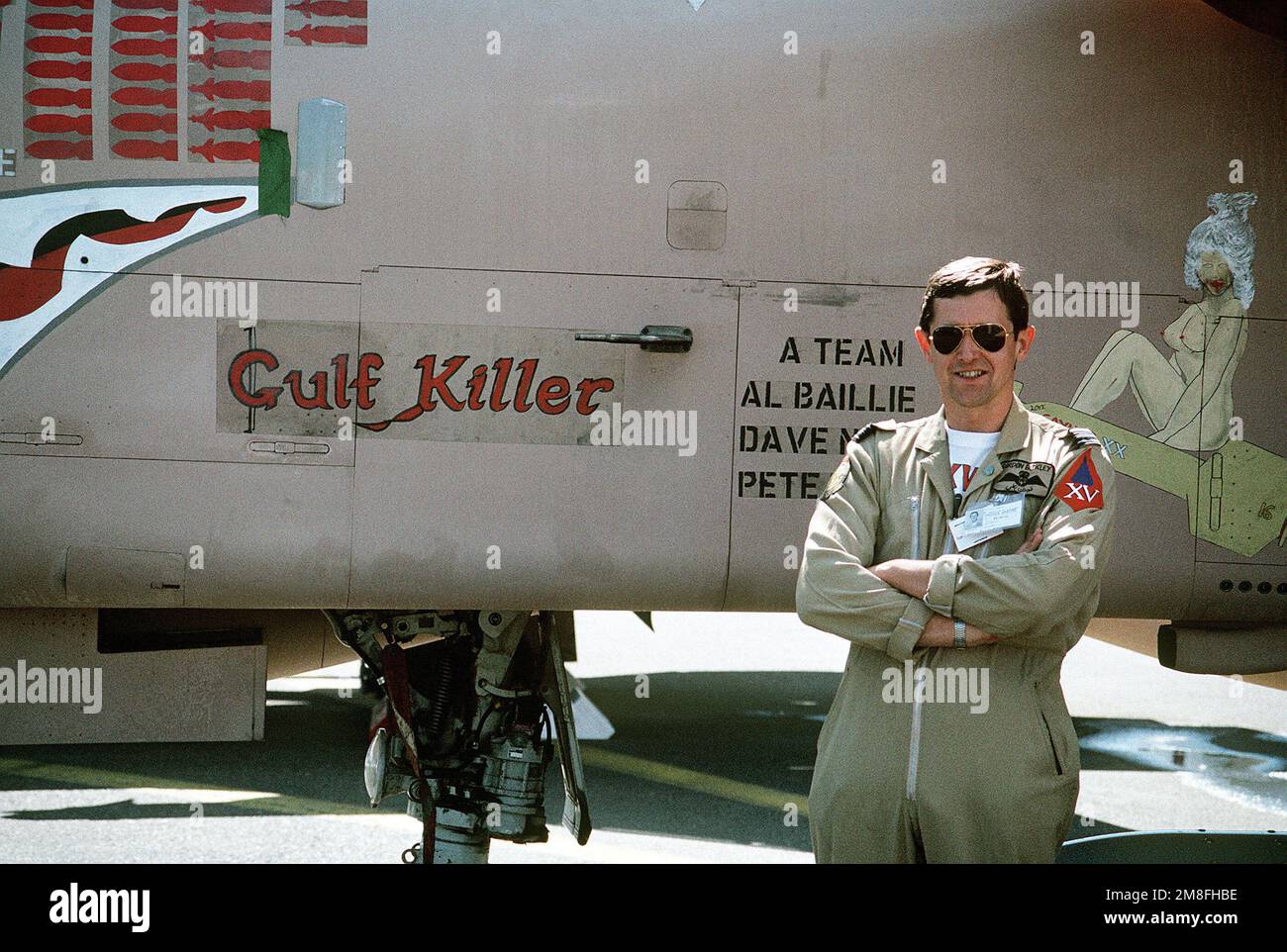 A pilot from No. XV Squadron, Royal Air Force, stands beside his GR ...
