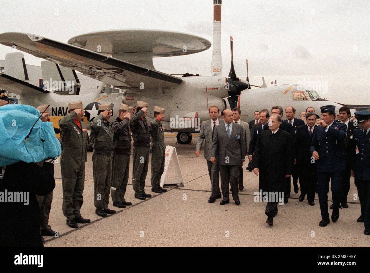 U.S. Navy personnel salute as French President Francois Mitterrand ...