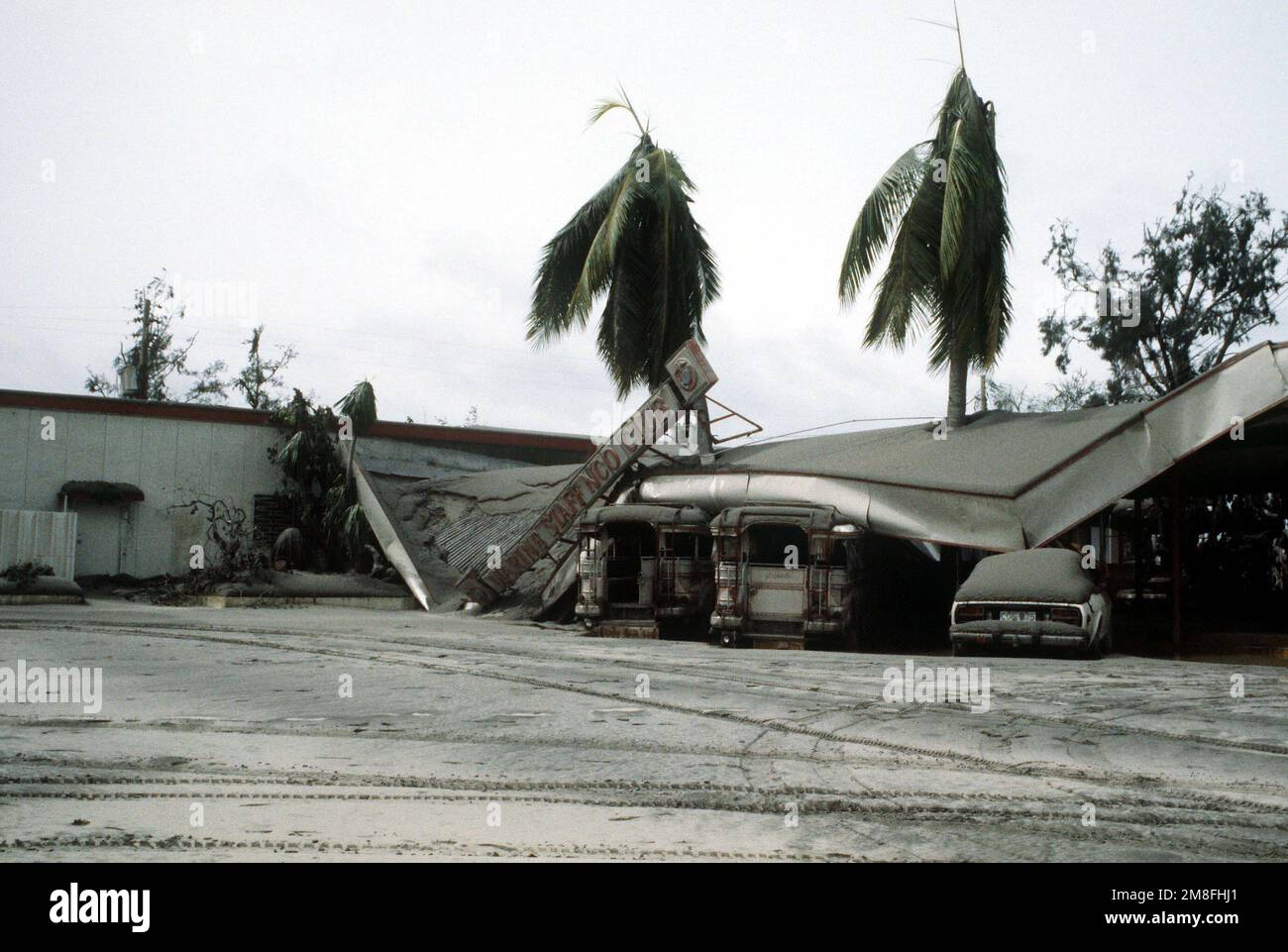 Two jeepneys and a privately owned vehicle lie under the collapsed awning at the Marine STAFF ...
