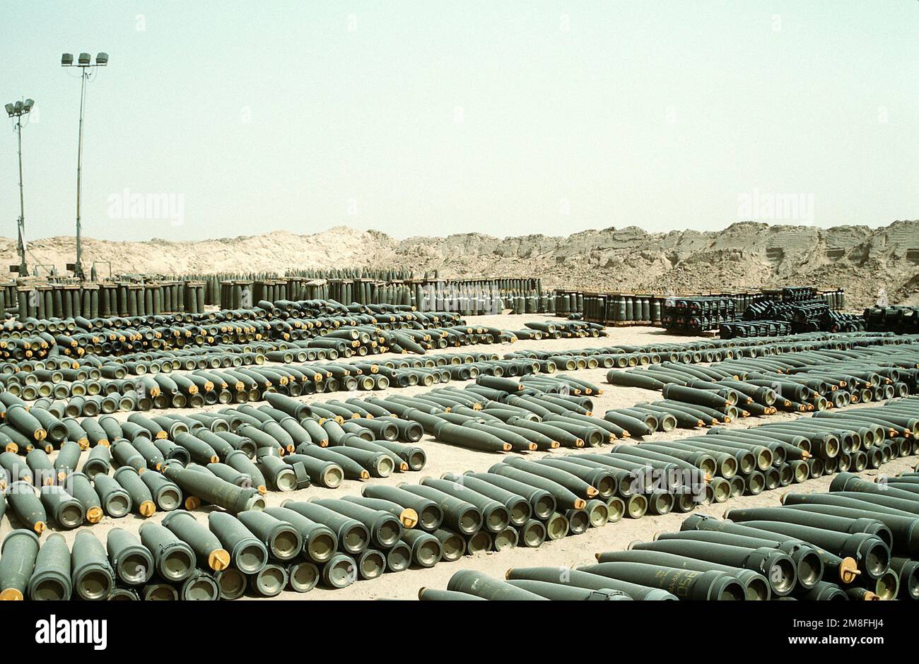 Rows of 155mm howitzer projectiles line a holding area at Ammo Supply ...