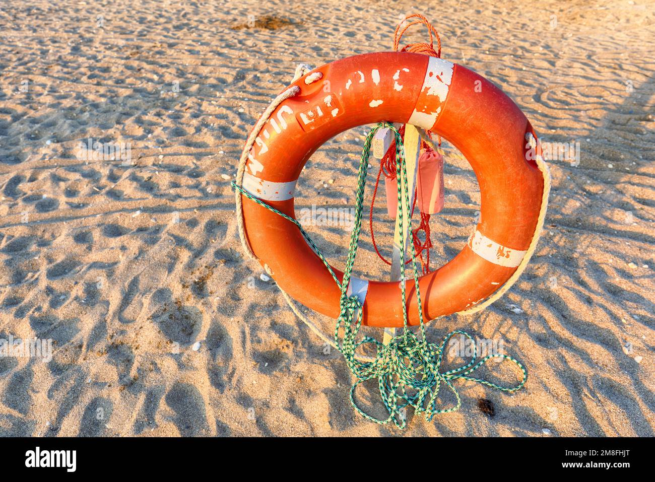 Old life-buoy ring on a sand sea beach Stock Photo - Alamy