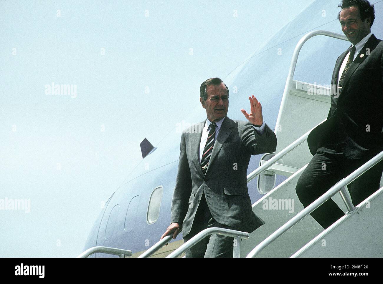 President George Bush greets those assembled to meet him as he steps ...