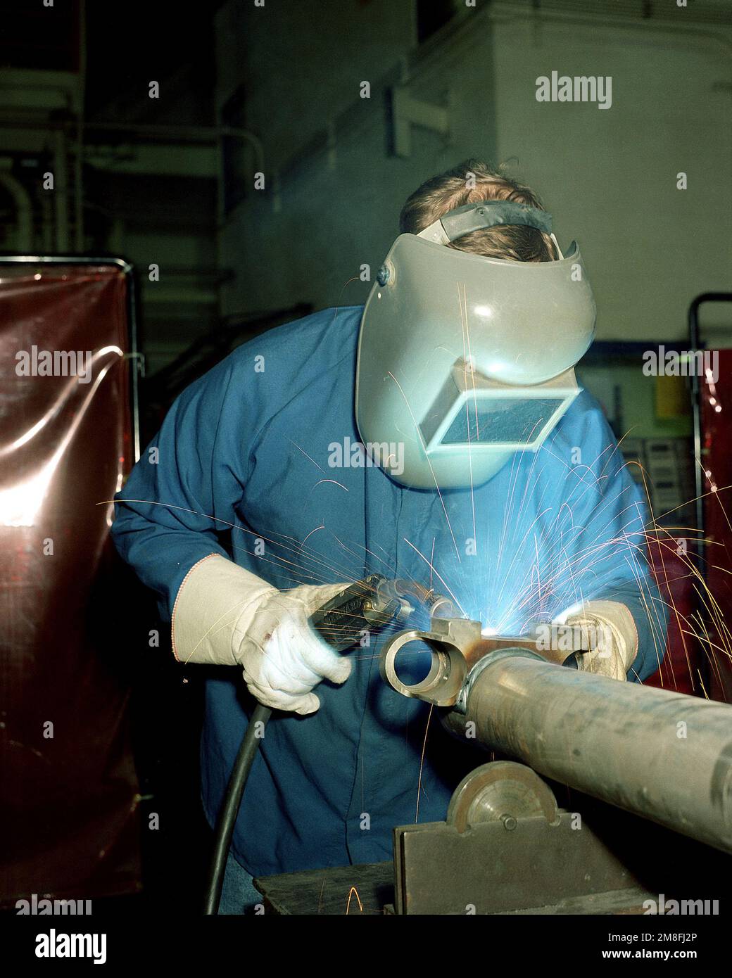 John Kakert, an employee of the Rock Island Army Arsenal, welds the ...