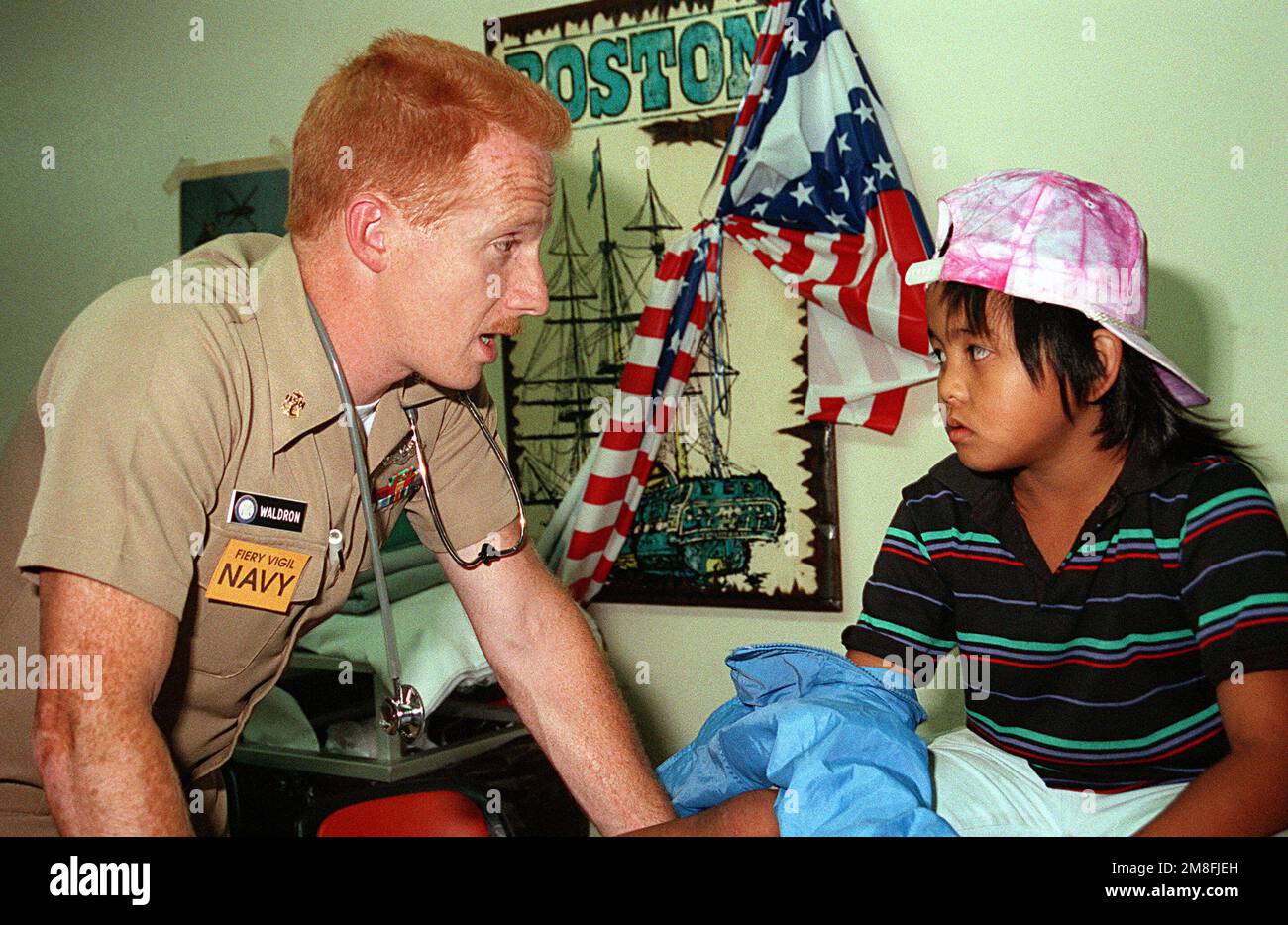 CHIEF Hospital Corpsman Dirk Waldron reassures a child in a medical ...