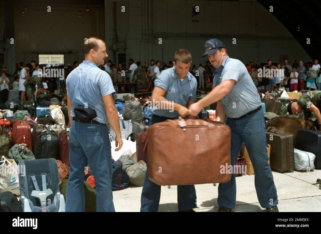 Sailors from U.S. Naval Station, Guam, move luggage at a temporary ...