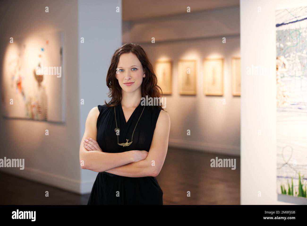 Representing the artists. A portrait of a young woman standing in front ...