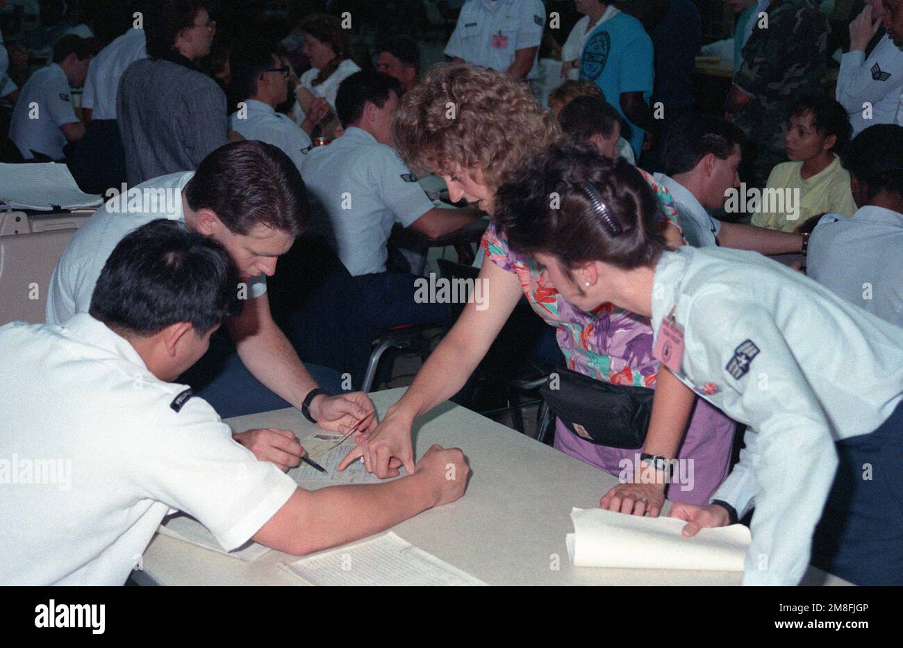 Military personnel assist evacuees arriving from Clark Air Force Base ...
