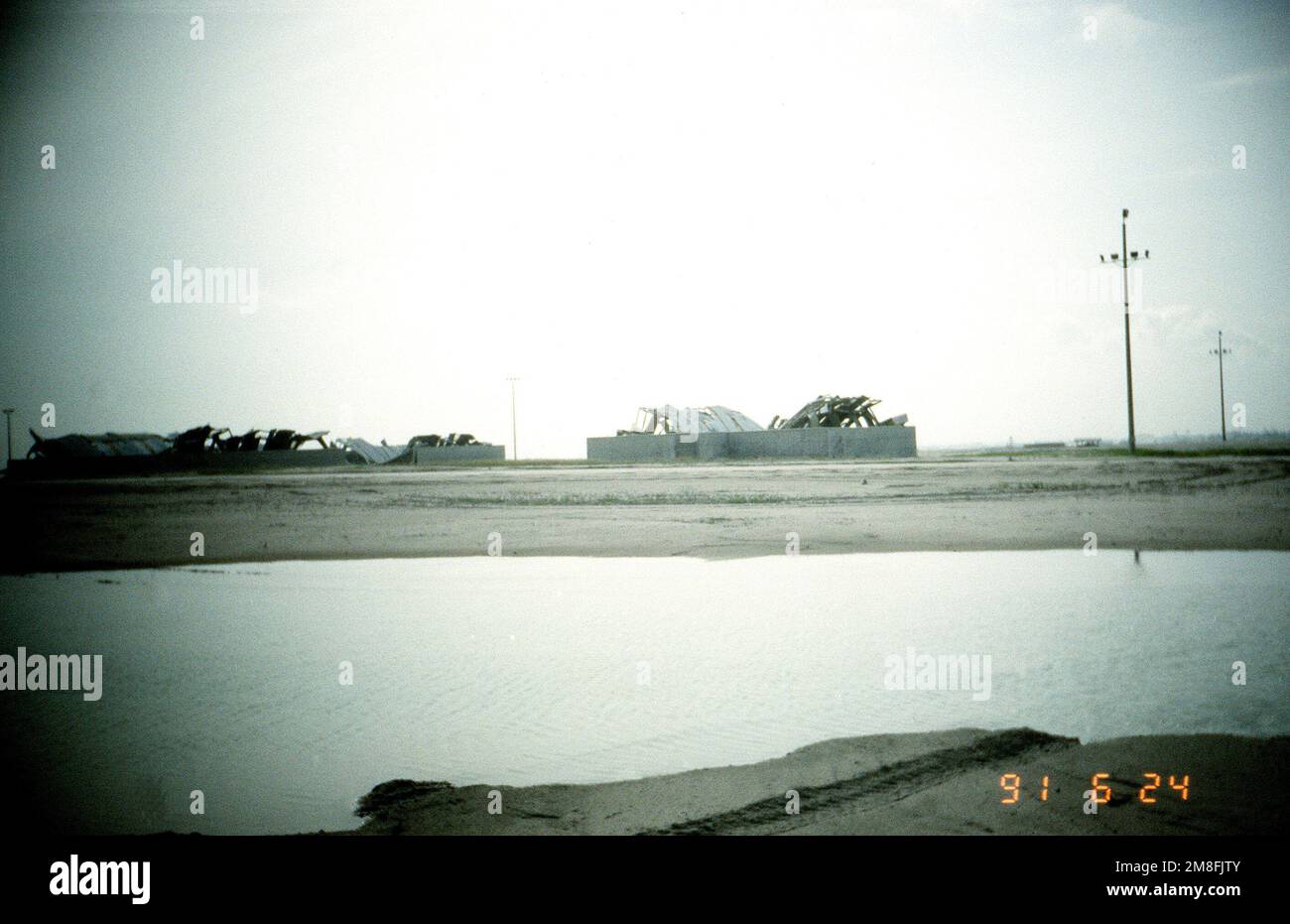 A view of several aircraft weather shelters that collapsed under the ...