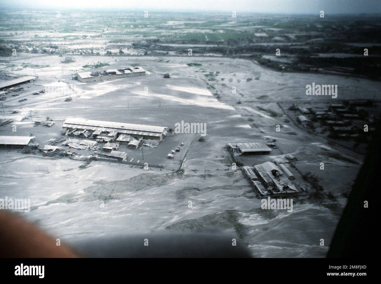 An aerial view of a portion of the base, showing warehouses damaged by ...