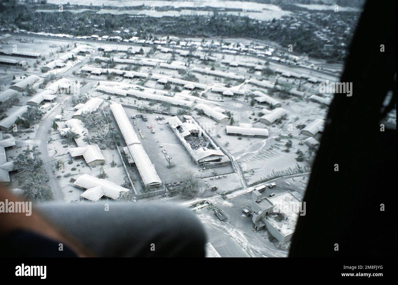 An aerial view of a portion of the base, showing a damaged building ...