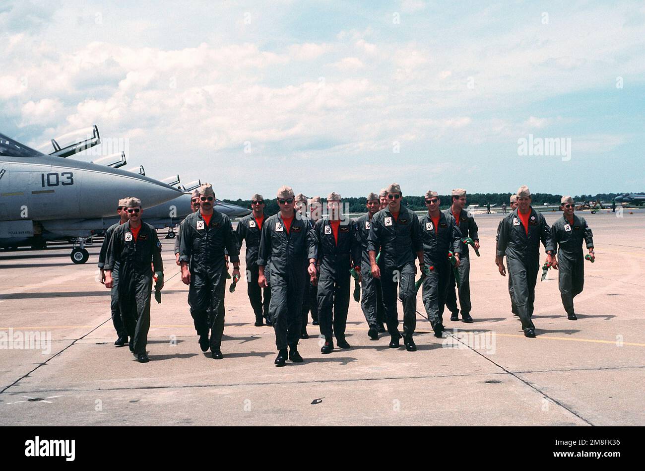 The pilots and radar intercept officers of Fighter Squadron 41 (VF-41) walk together past their ...