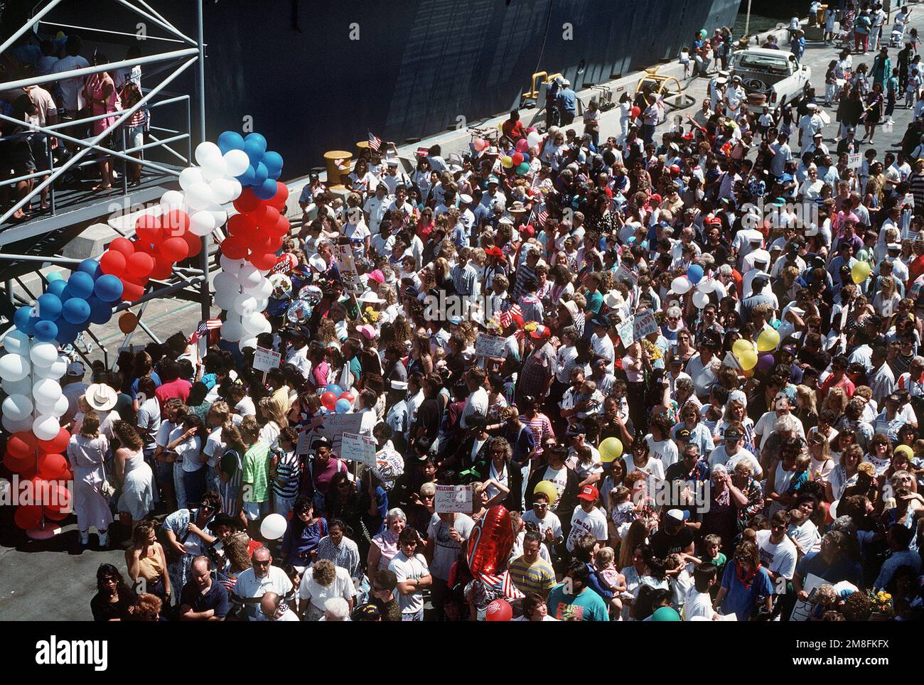 Family members and friends stand in line on the pier to go aboard the ...