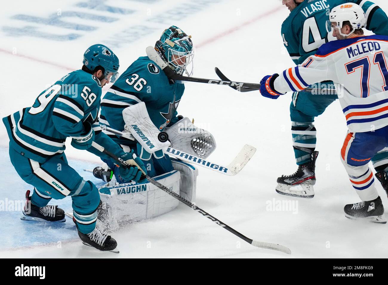San Jose Sharks goaltender Kaapo Kahkonen (36) deflects an Edmonton ...
