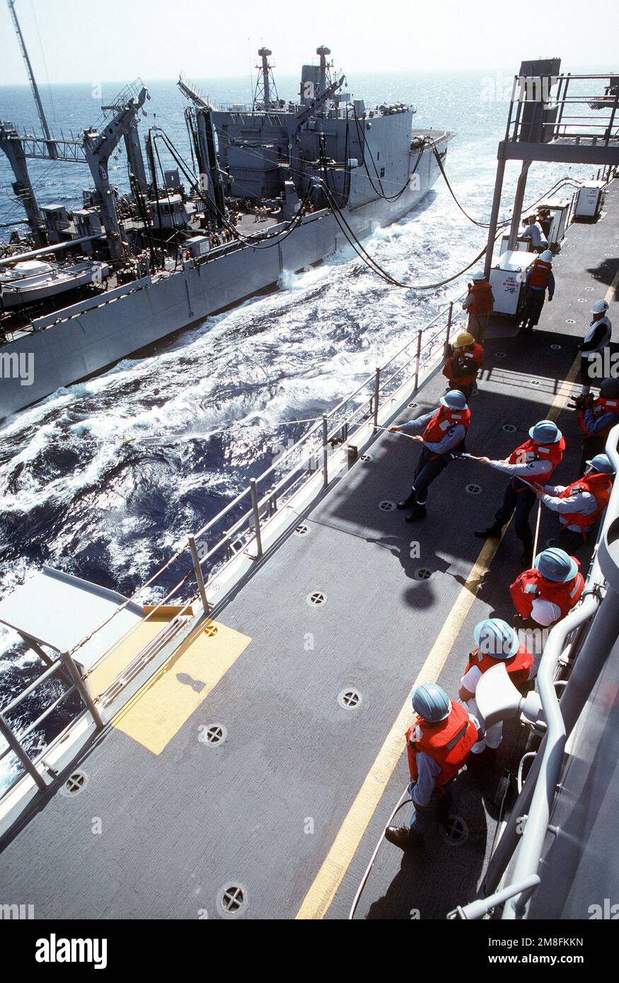 Sailors aboard the amphibious assault ship USS WASP (LHD-1) haul in on ...
