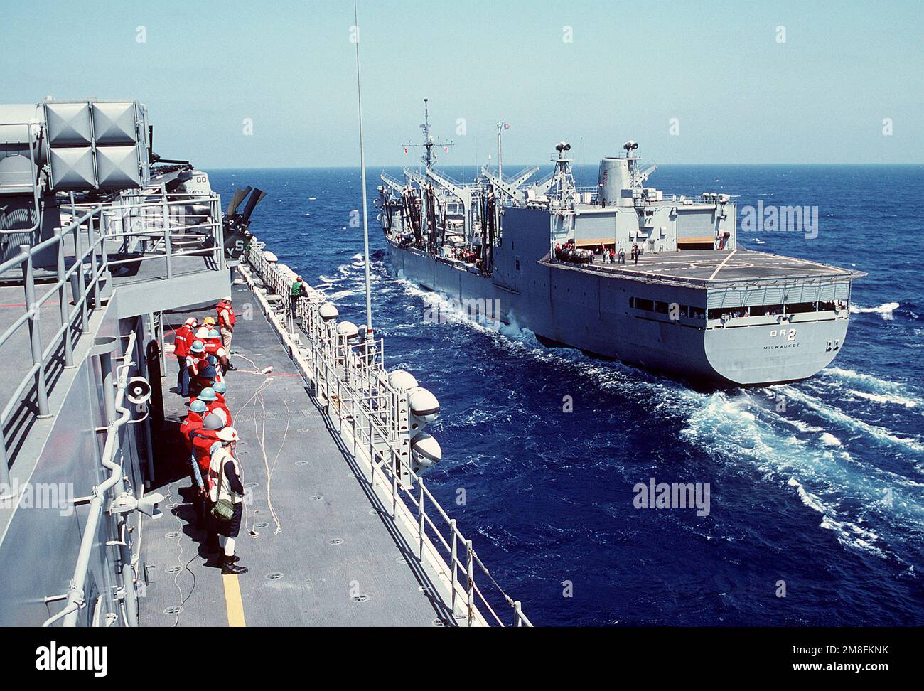 The amphibious assault ship USS WASP (LHD-1), left, comes alongside the ...