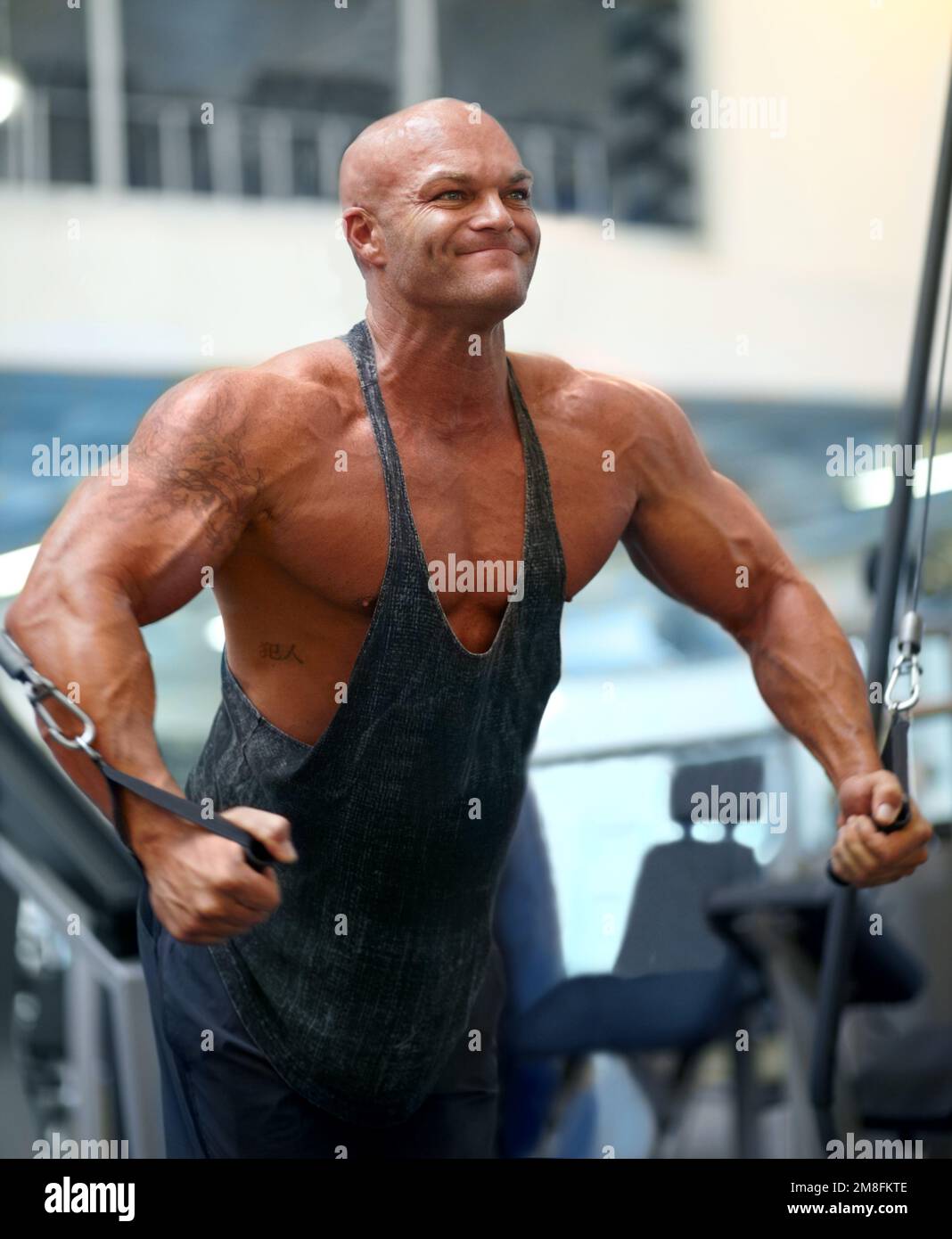 Feeling stronger by the minute. A male bodybuilder using exercise ...