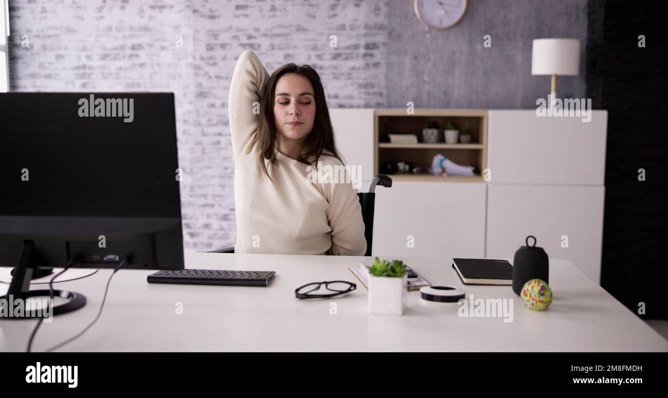 Arms Stretch Exercise Sitting At Desk In Office Stock Photo - Alamy