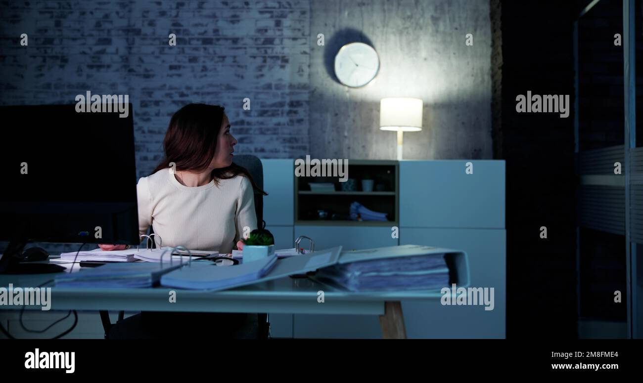 Businesswoman At Office Looking At Clock On Wall Stock Photo - Alamy