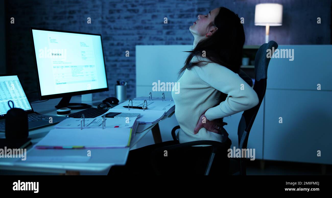 Young Businesswoman Having Back Pain While Sitting At Office Desk Stock ...