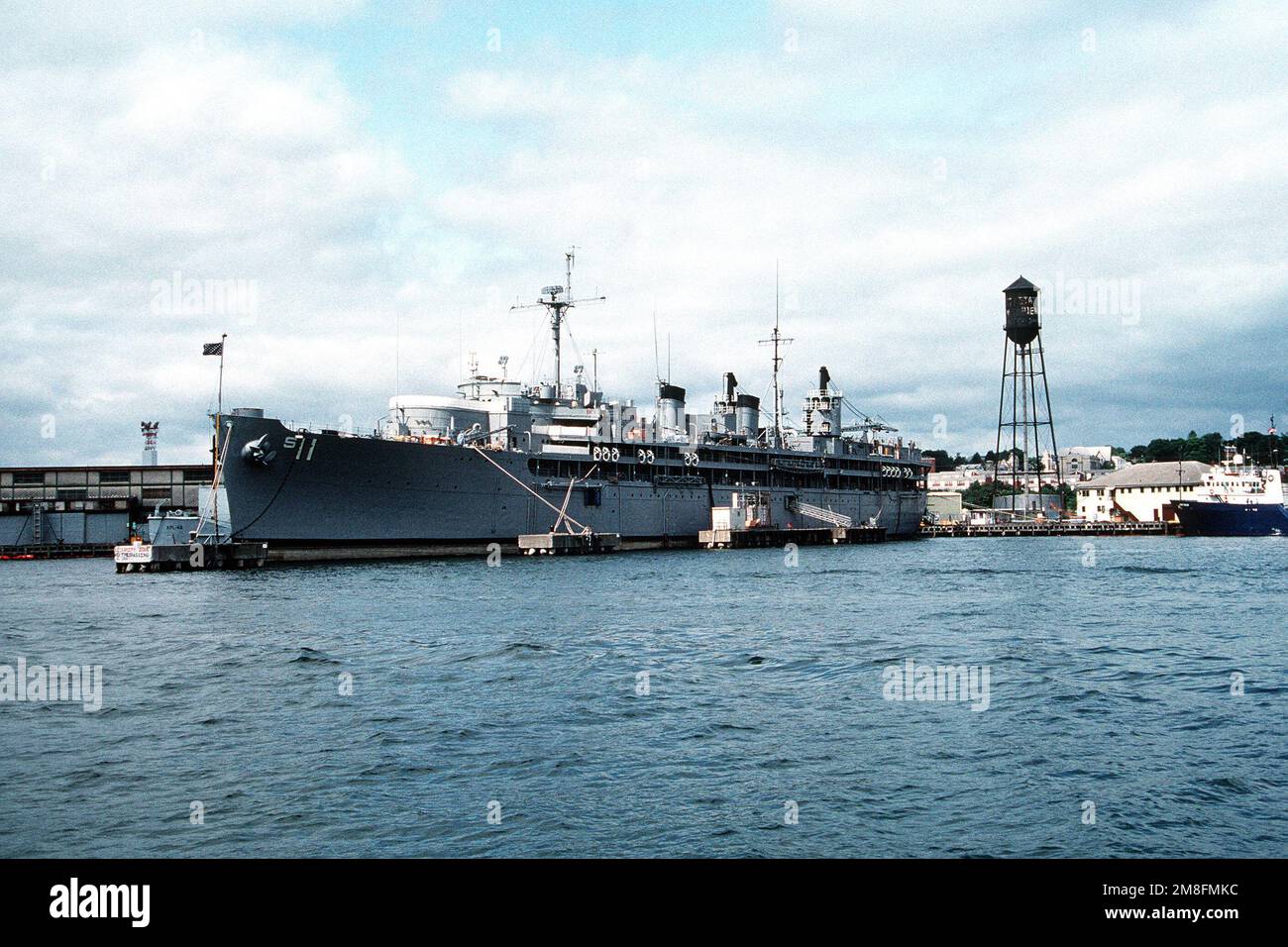 A port bow view of the submarine tender USS FULTON (AS 11) tied up at ...