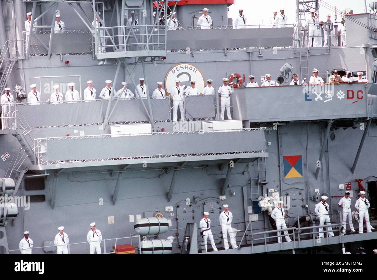 Crew members man the rails aboard the guided missile destroyer USS DAHLGREN (DDG-43) as the ship ...