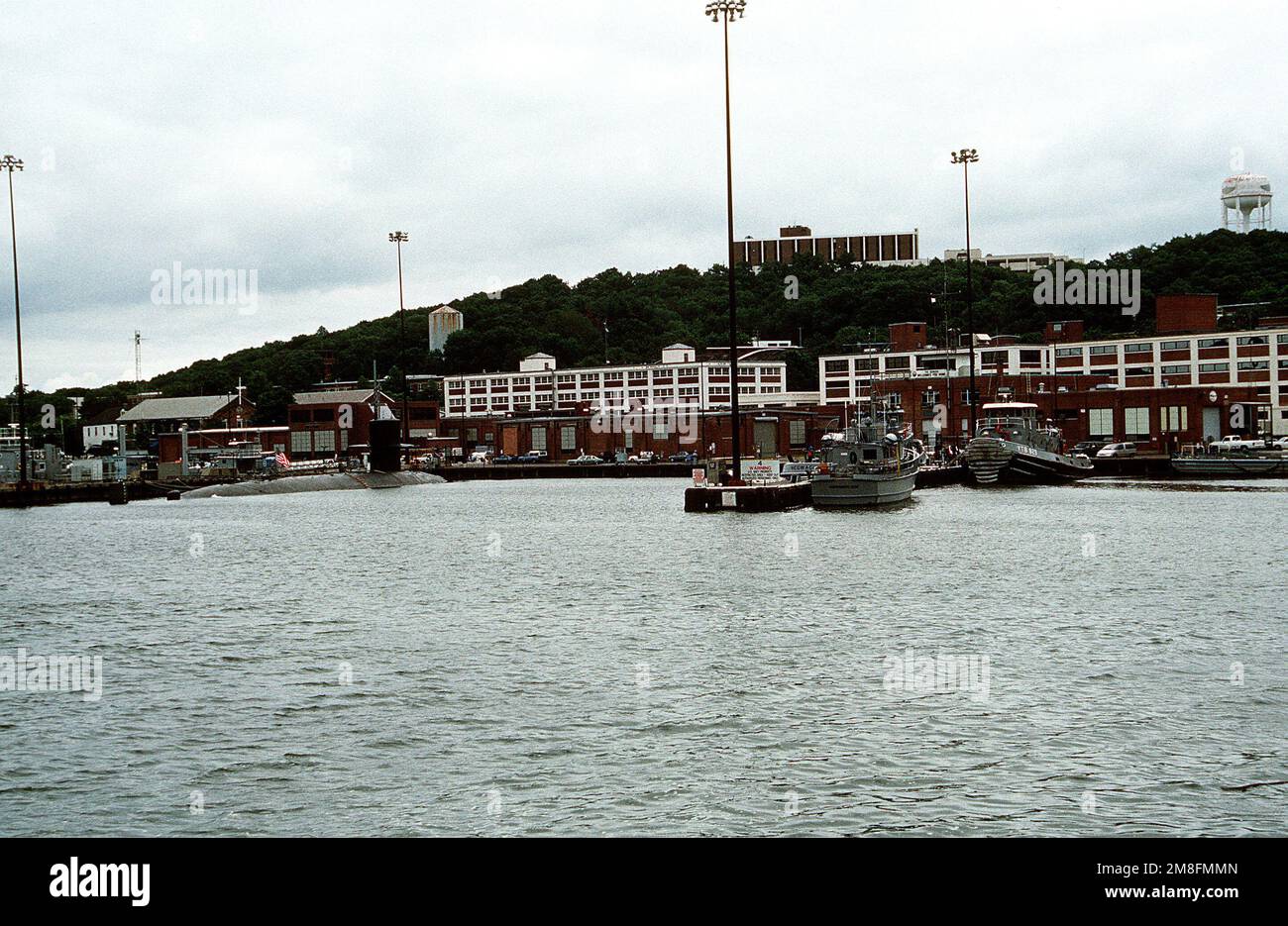 A Sturgeon class nuclear-powered attack submarine, the large harbor tug ...