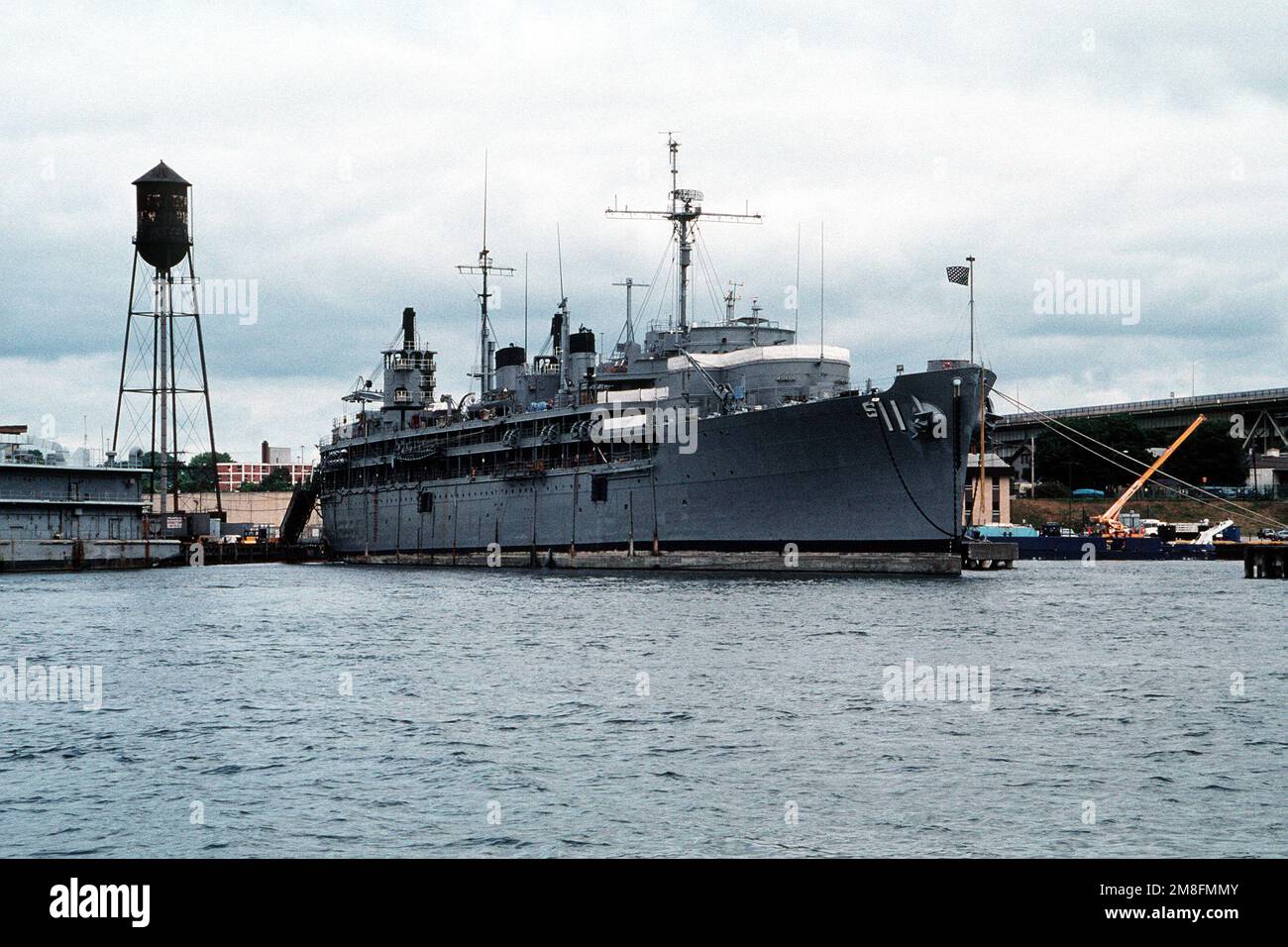 A starboard bow view of the submarine tender USS FULTON (AS 11) tied up ...