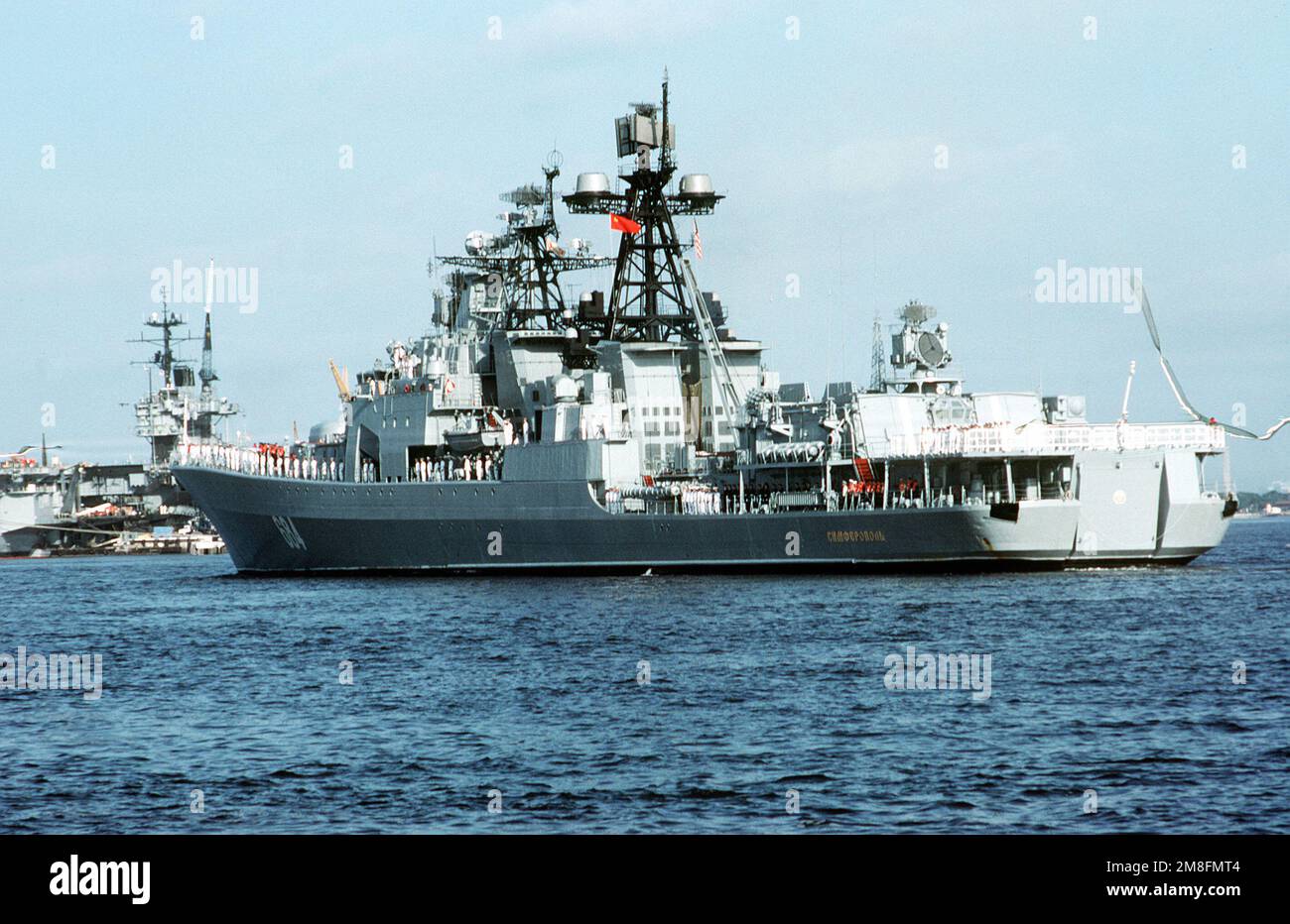 Crew members man the rails aboard the Soviet guided missile destroyer ...