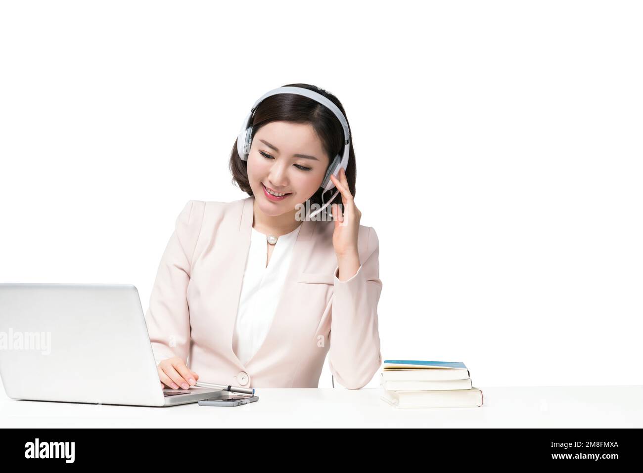 Young woman wearing a headset to use a computer Stock Photo - Alamy