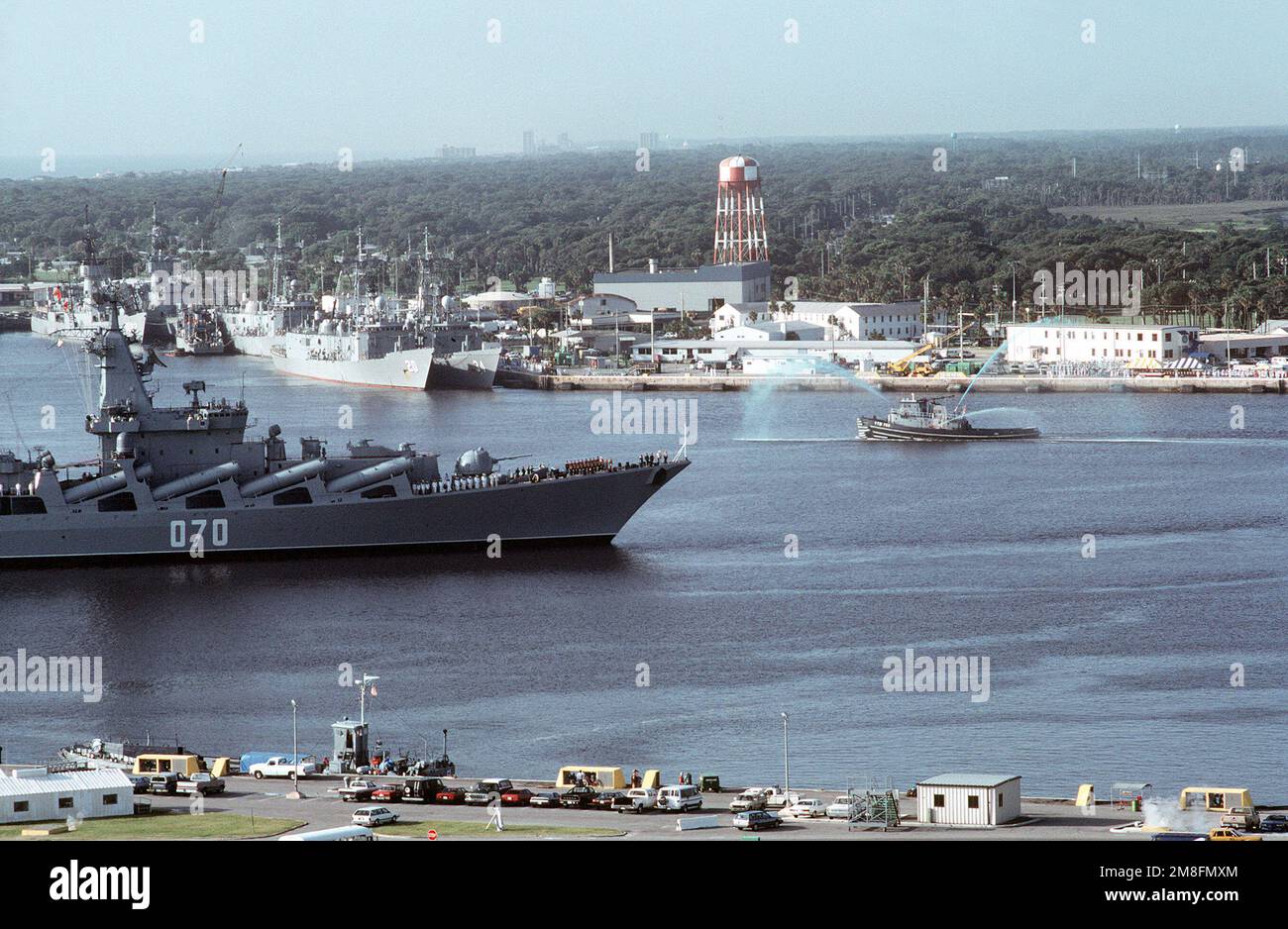 The large harbor tug CHESANING (YTB-769) sprays water in welcome as the ...